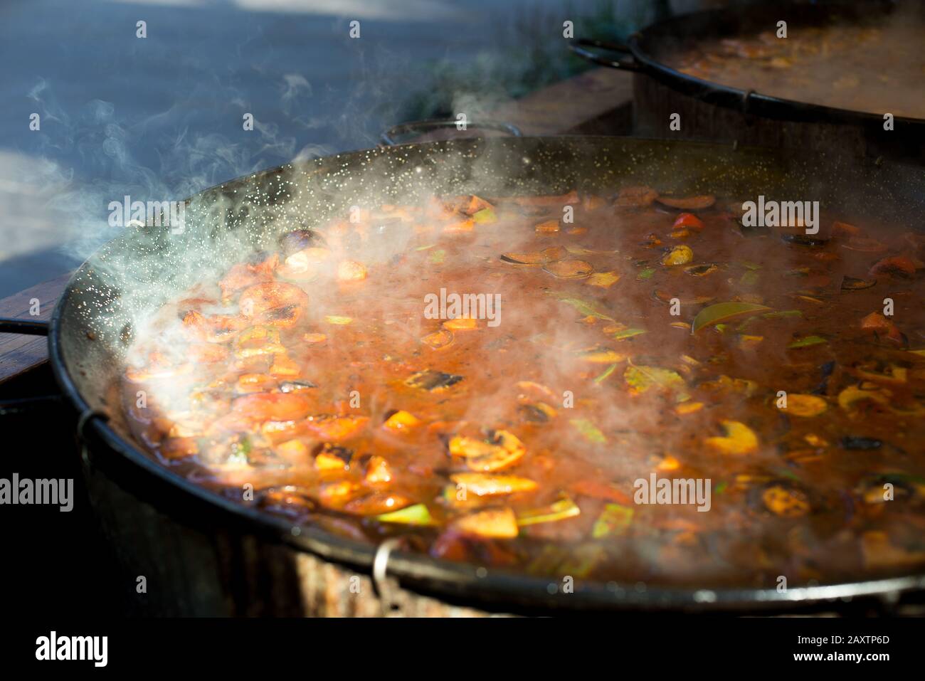 vegetarian curry cooking in hot steel pan at outdoor event Stock Photo ...