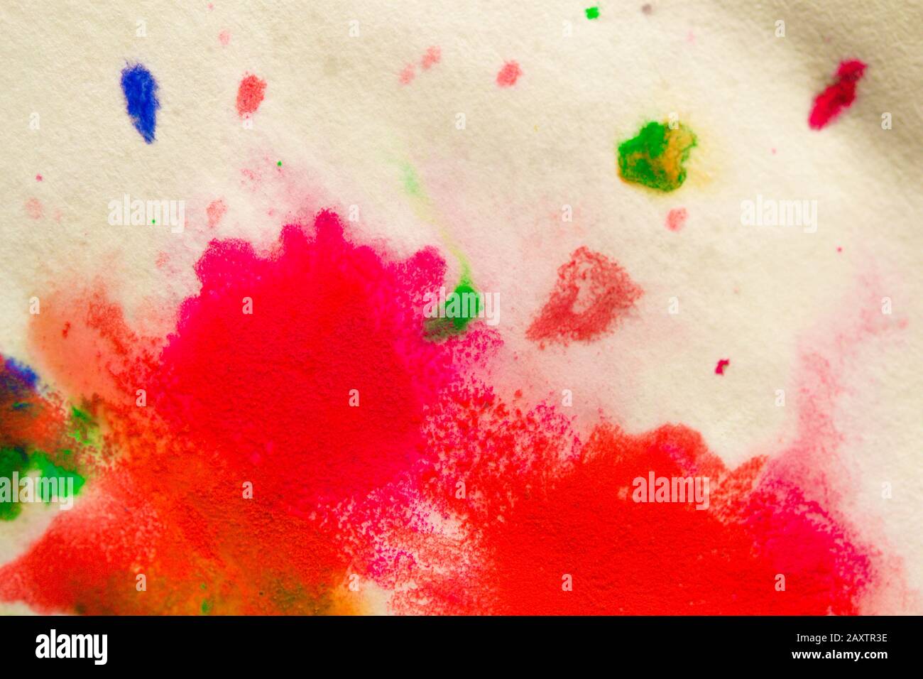 abstract spots splash of bright red, green, blue colors on white paper ...