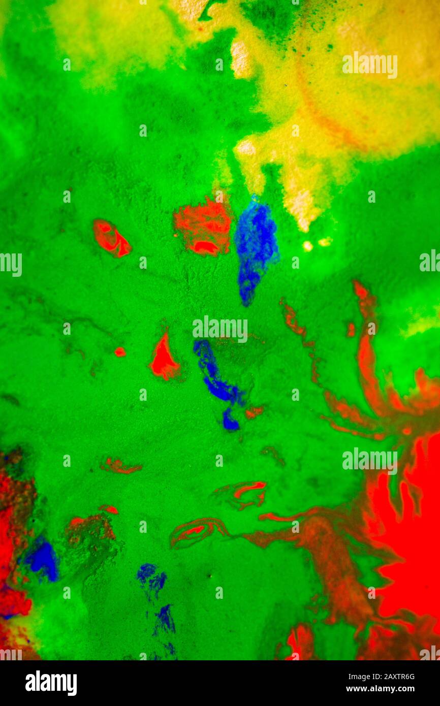 abstract spots splash of bright red, green, blue colors on white paper ...