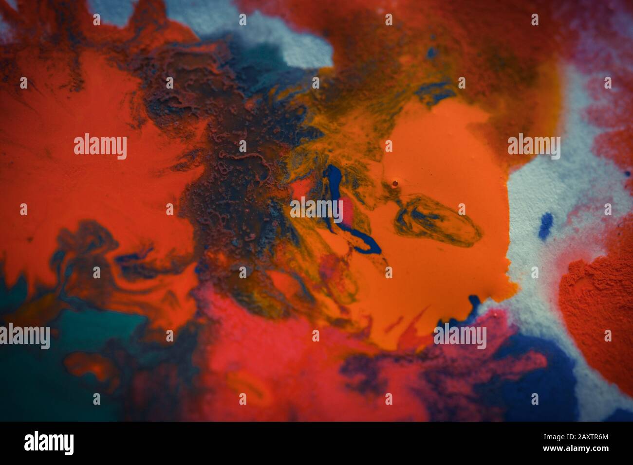 abstract spots splash of bright red, green, blue colors on white paper ...