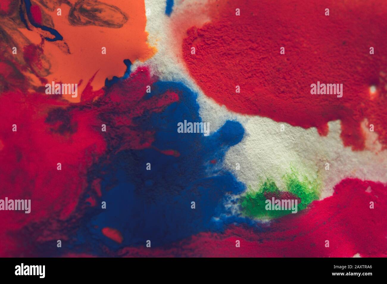 abstract spots splash of bright red, green, blue colors on white paper ...