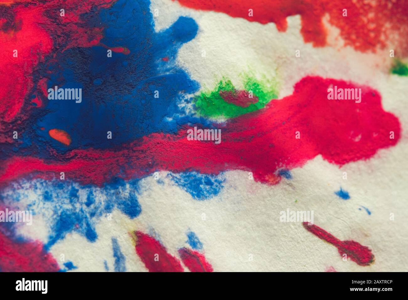 abstract spots splash of bright red, green, blue colors on white paper ...