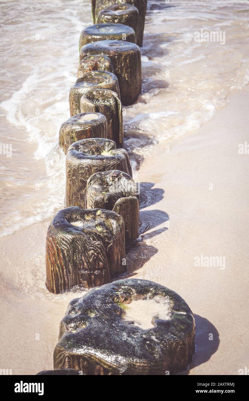 Vertical high angle shot of small wooden docks on the sandy beach Stock ...