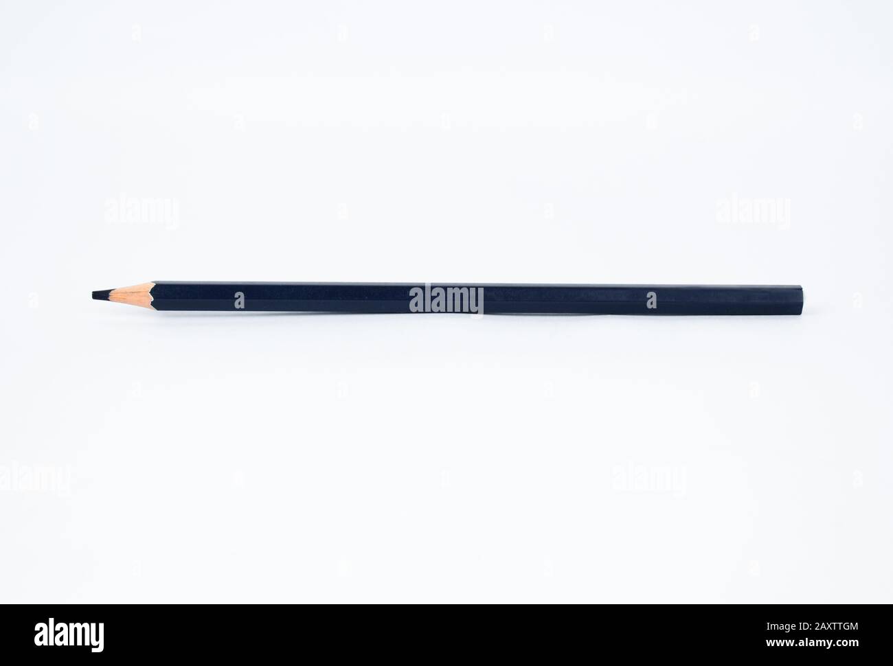 A deep navy blue colored sharp wood pencil crayon isolated on a clear ...