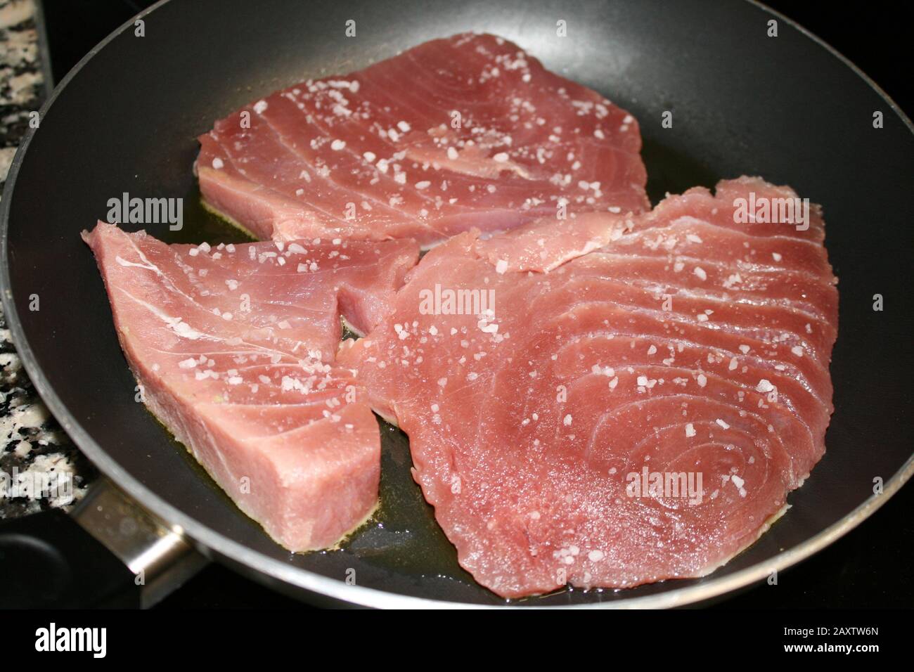 Raw tuna fillet. Preparation. Close-up shooting Stock Photo - Alamy