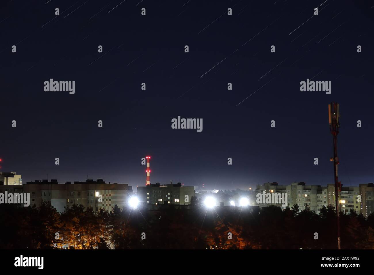 shooting stars shine in the night sky above the city Stock Photo - Alamy