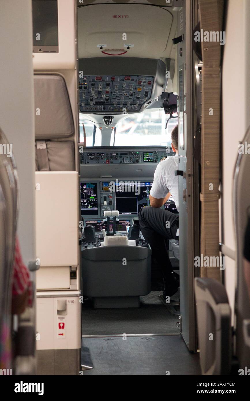 View through open door of the flight cockpit of a Bombardier C series ...