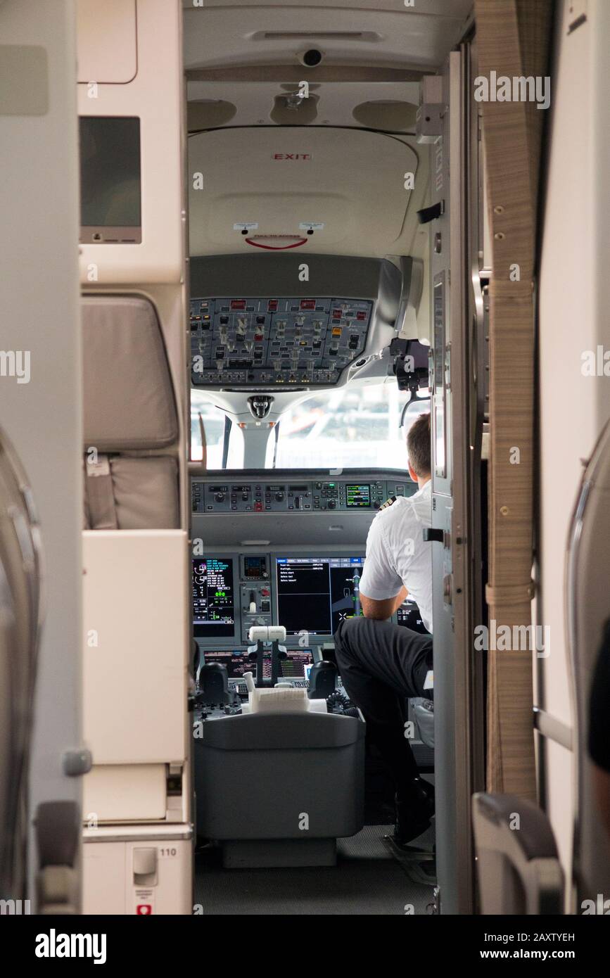View through open door of the flight cockpit of a Bombardier C series ...