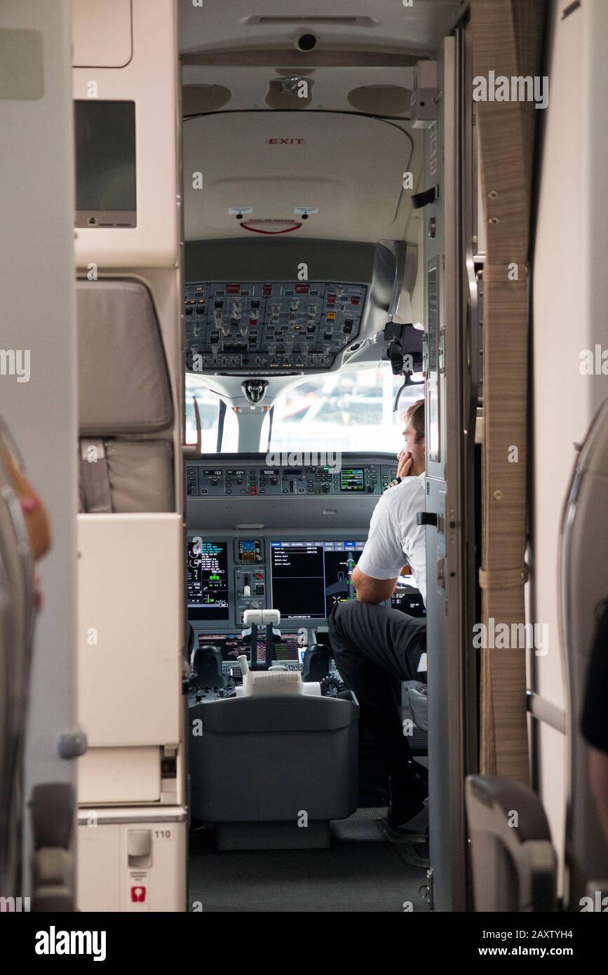 View through open door of the flight cockpit of a Bombardier C series ...