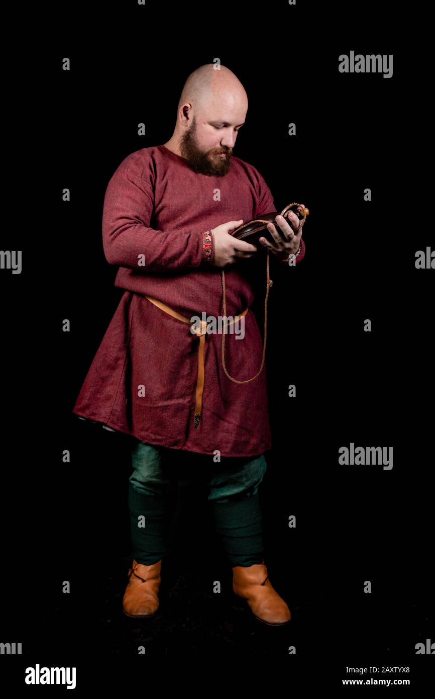 Overweight bearded man in the image of a medieval merchant. The ...