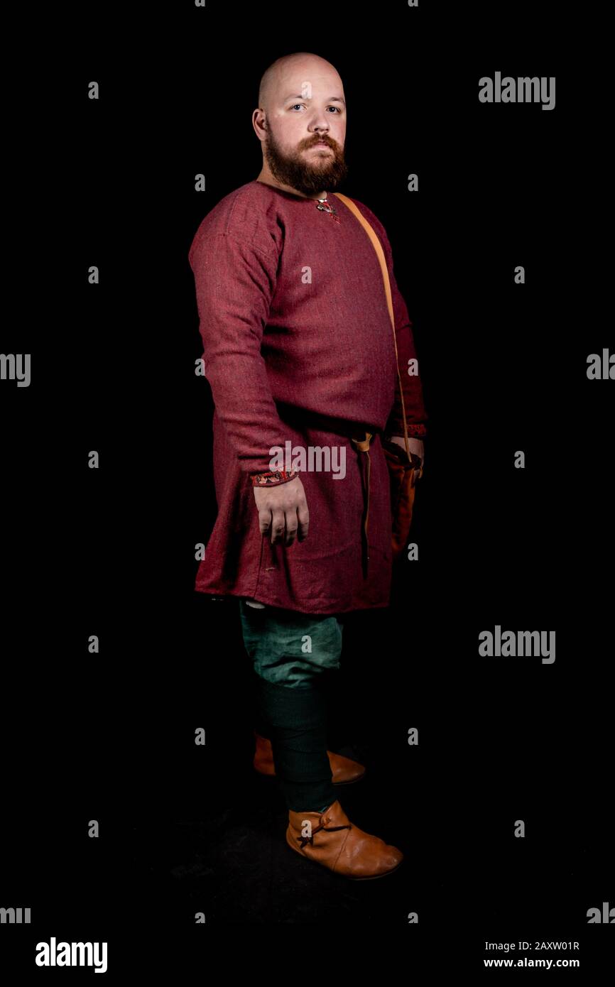 Overweight bearded man in the image of a medieval merchant. The ...