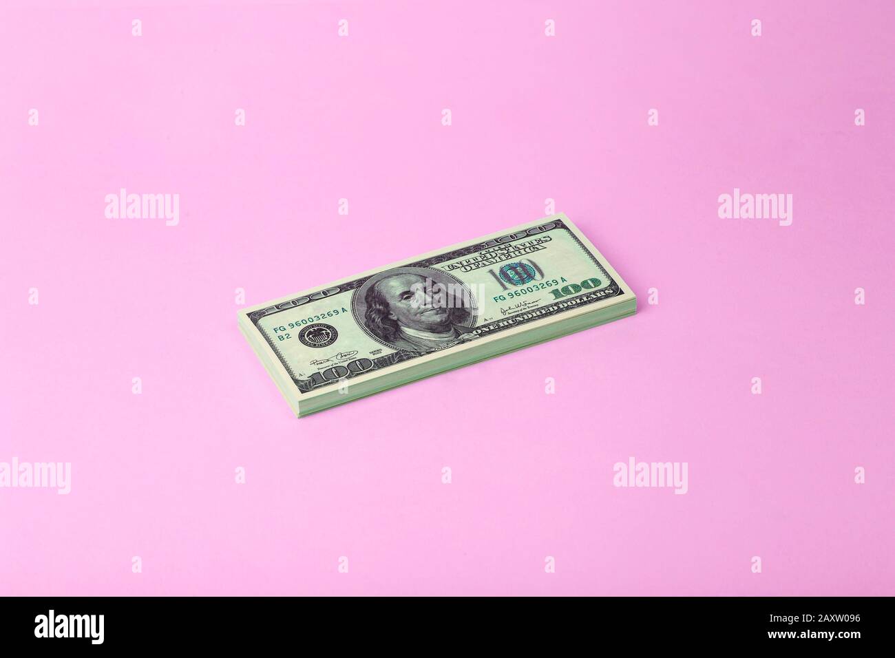 A pack of dollars (100 dollars banknotes) on a colored minimal ...
