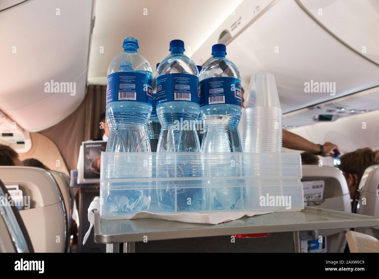 Flight attendant serving water passenger hi-res stock photography and ...