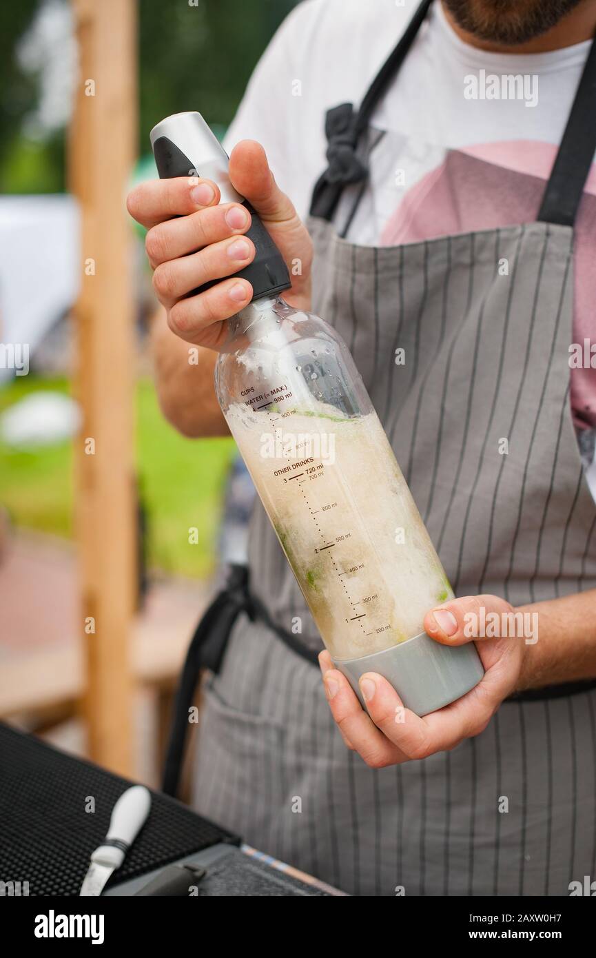 Making homemade lemonade. The guy is making lemonade. Street food Stock ...