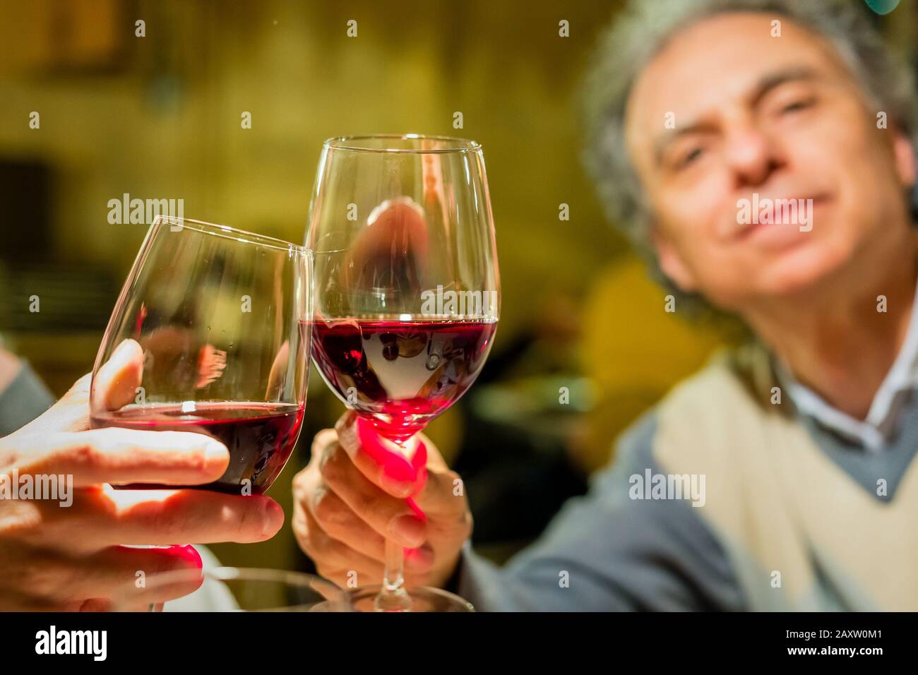 old man toasts with a glass of red wine Stock Photo - Alamy