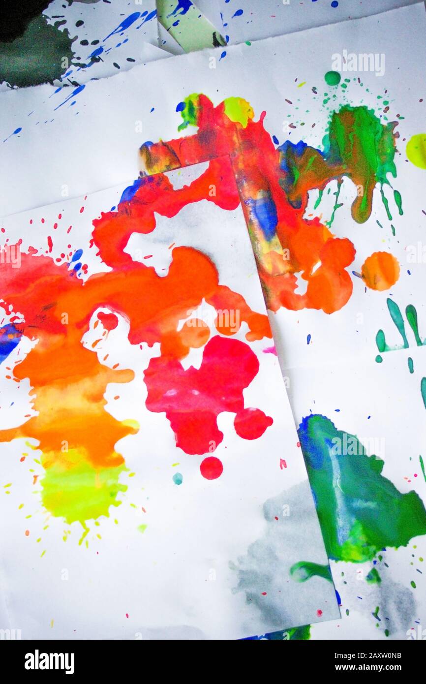 Many red colored blots on white paper with streaks. Abstract creative ...