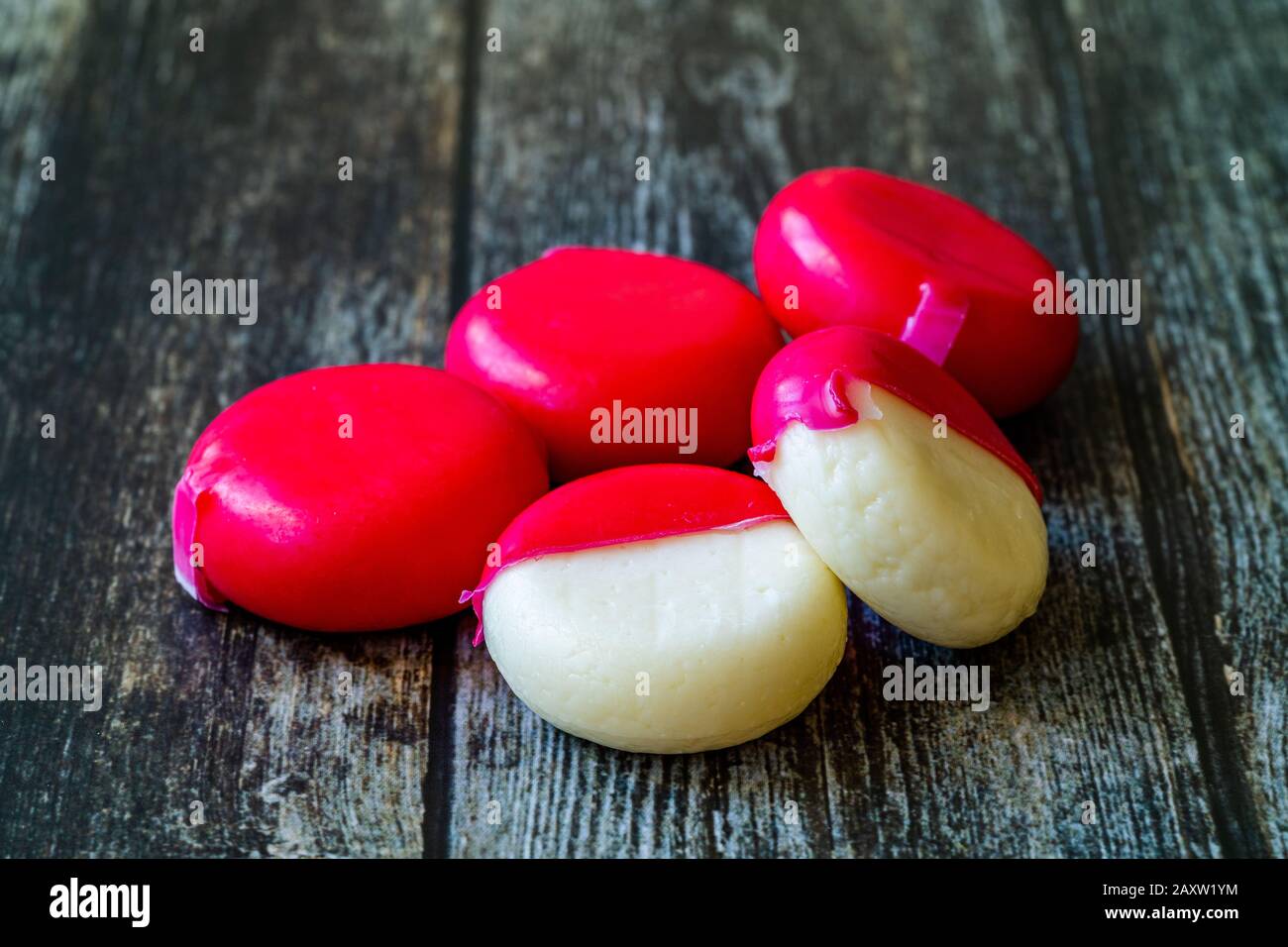 Babybel Cheese in Red Wex on Wooden Surface Ready to Eat. Instant Food ...
