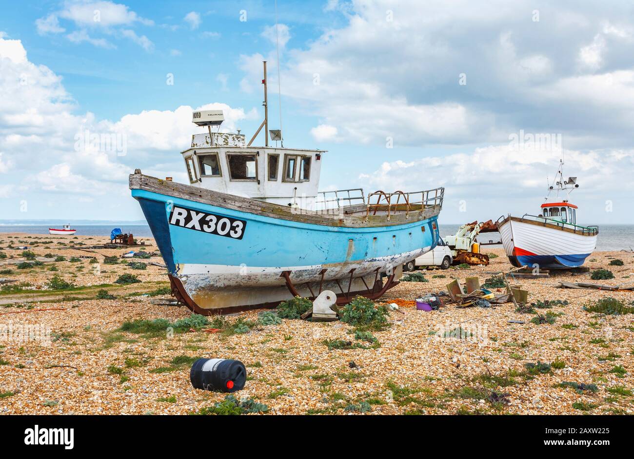 Old fishing boats hauled up and beached on the shingle beach at ...