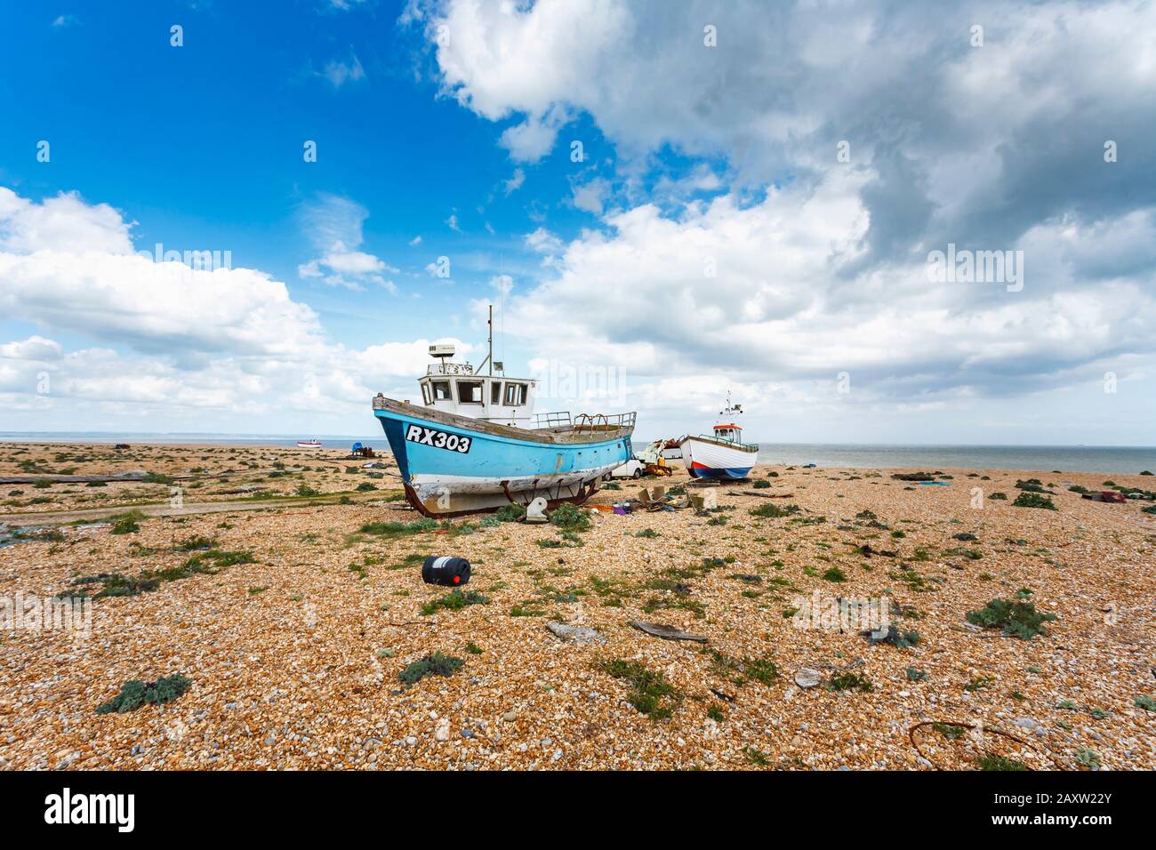 Old fishing boats hauled up and beached on the shingle beach at ...