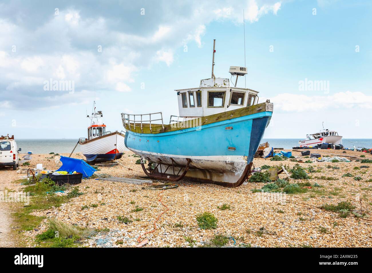 Old fishing boats hauled up and beached on the shingle beach at ...