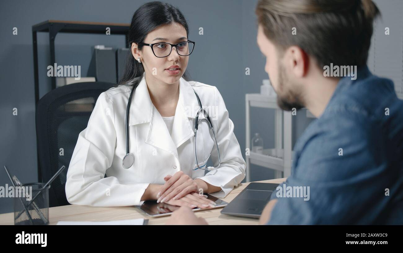 Female doctor listening to patient Stock Photo - Alamy