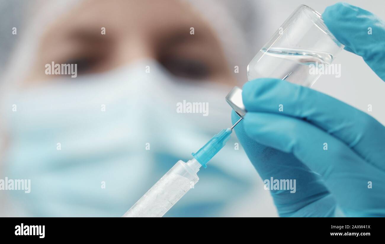 Medical person filling syringe close-up Stock Photo - Alamy
