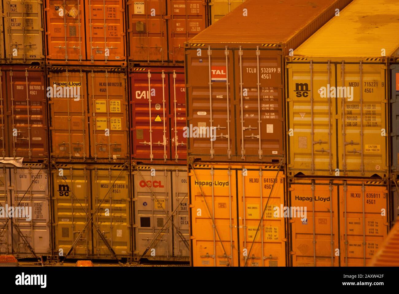 Stacked containers dockside at night time Stock Photo - Alamy