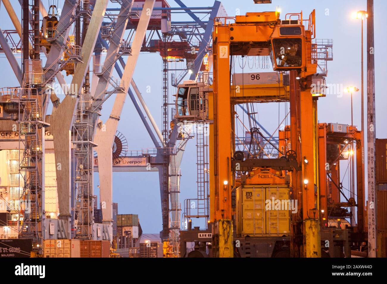 Container movers moving containers around port terminal for loading on ...