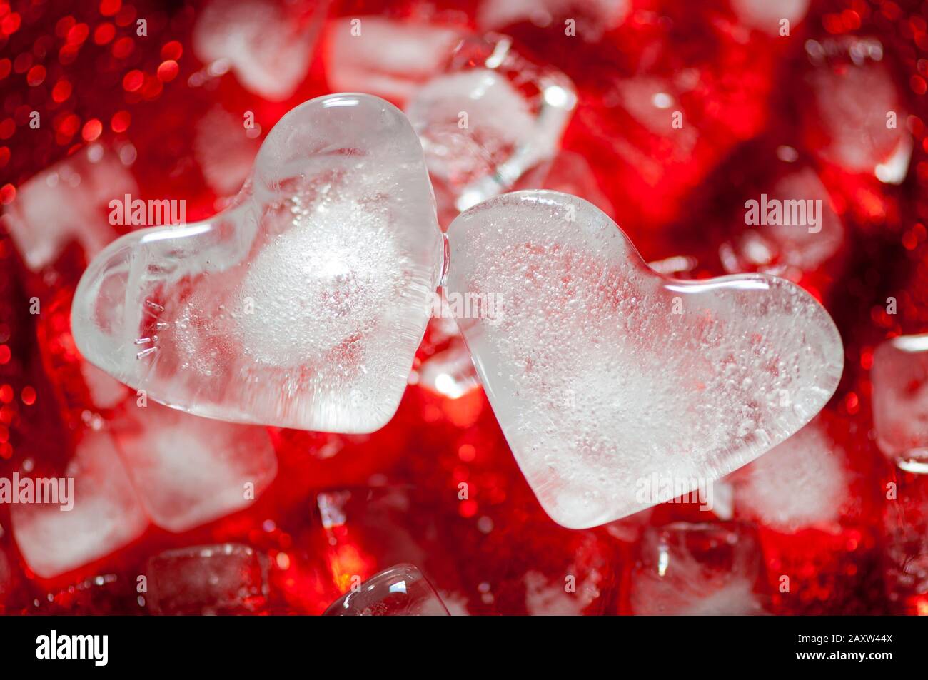 Pile of cold hearts of pure ice shining against red background Stock ...
