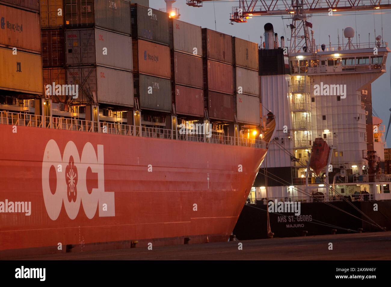 Large container ship loaded at dock at night time Stock Photo - Alamy