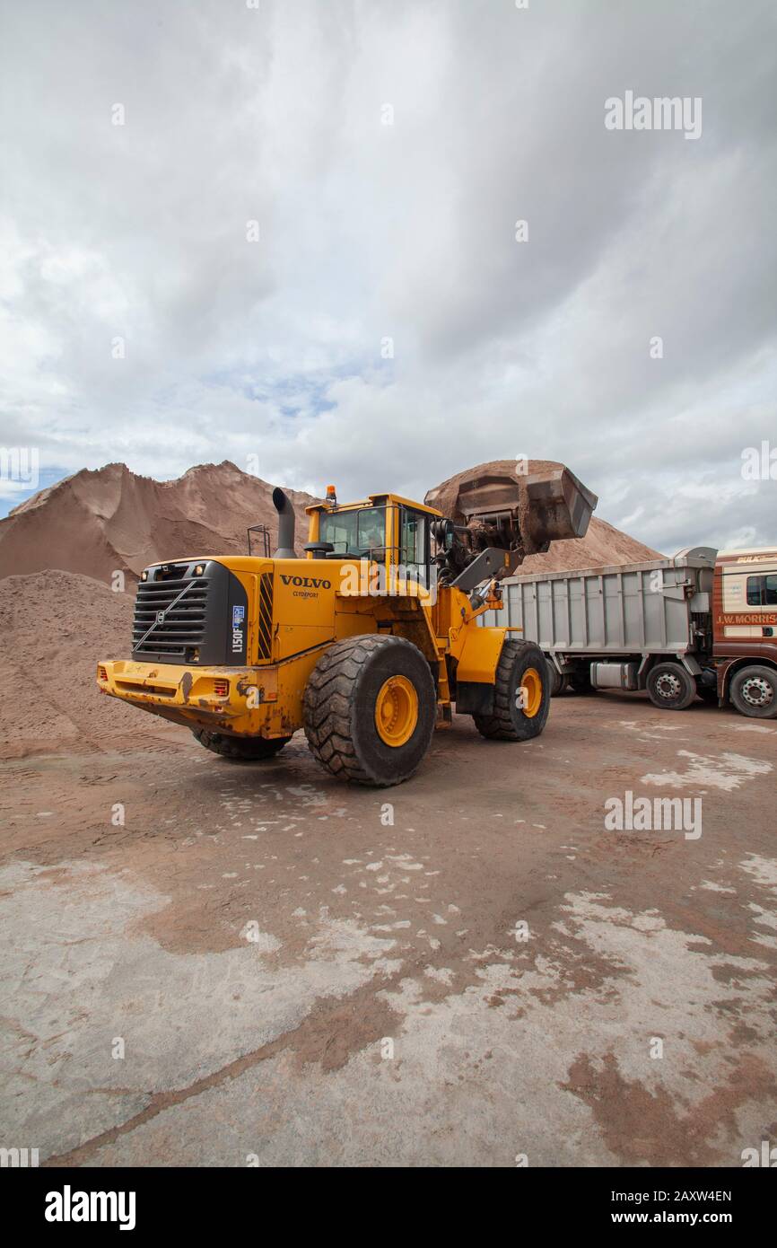 Volvo digger truck moving dry bulk goods in warehouse Stock Photo - Alamy