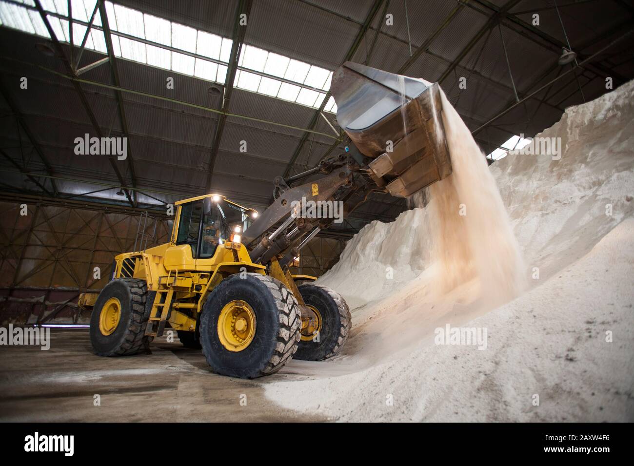 Volvo digger truck moving dry bulk goods in warehouse Stock Photo - Alamy