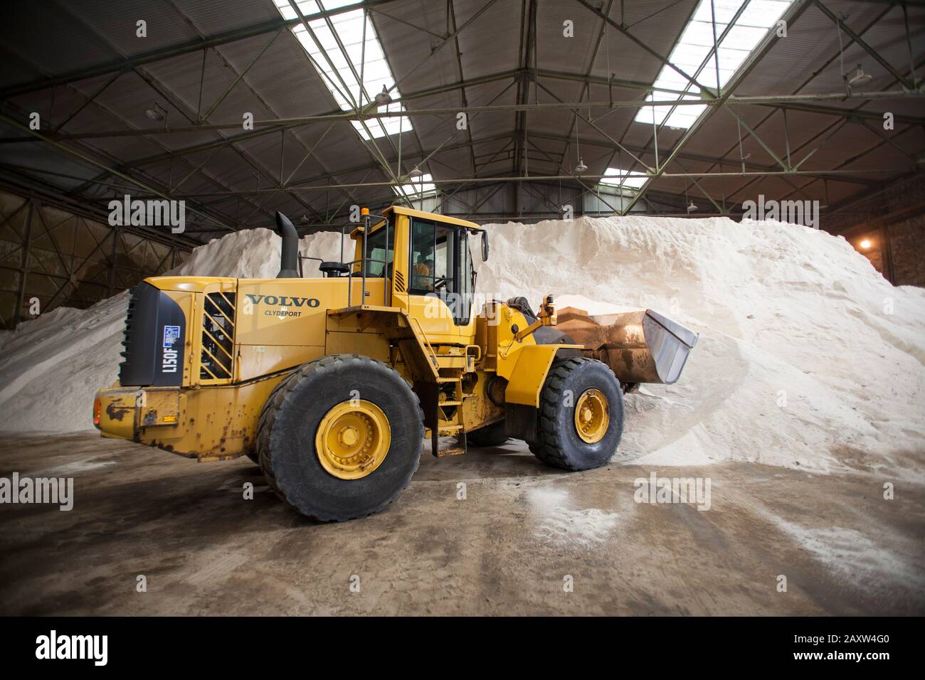 Volvo digger truck moving dry bulk goods in warehouse Stock Photo - Alamy