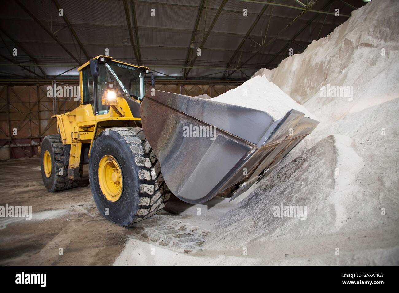 Volvo digger truck moving dry bulk goods in warehouse Stock Photo - Alamy