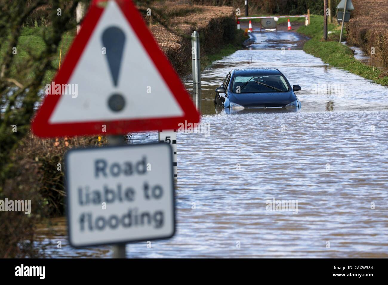 A car is stuck in flood water near Peasmarsh, Somerset, where heavy ...