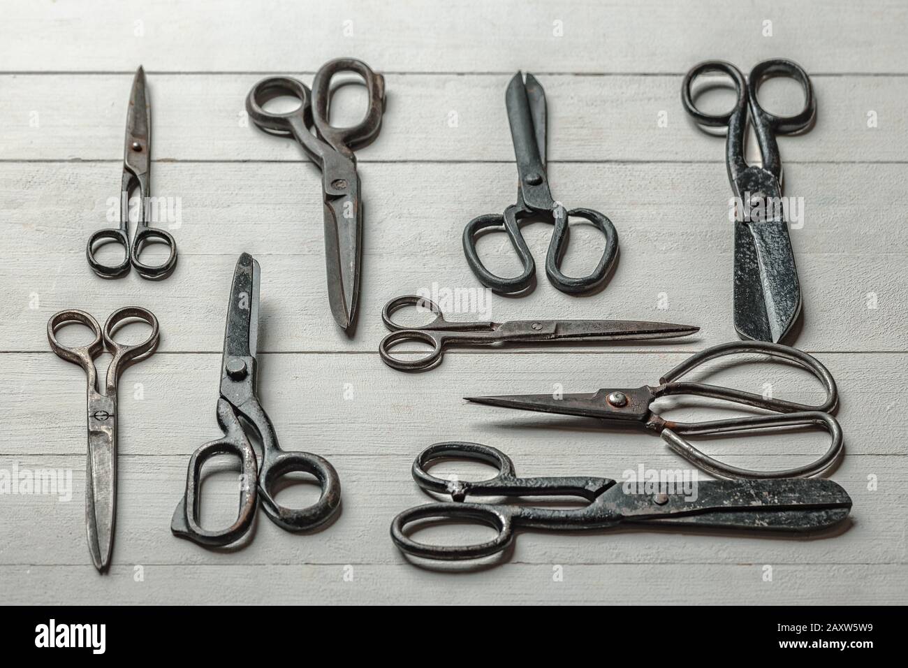 Vintage steel scissors on wooden table background. Old-fashioned ...