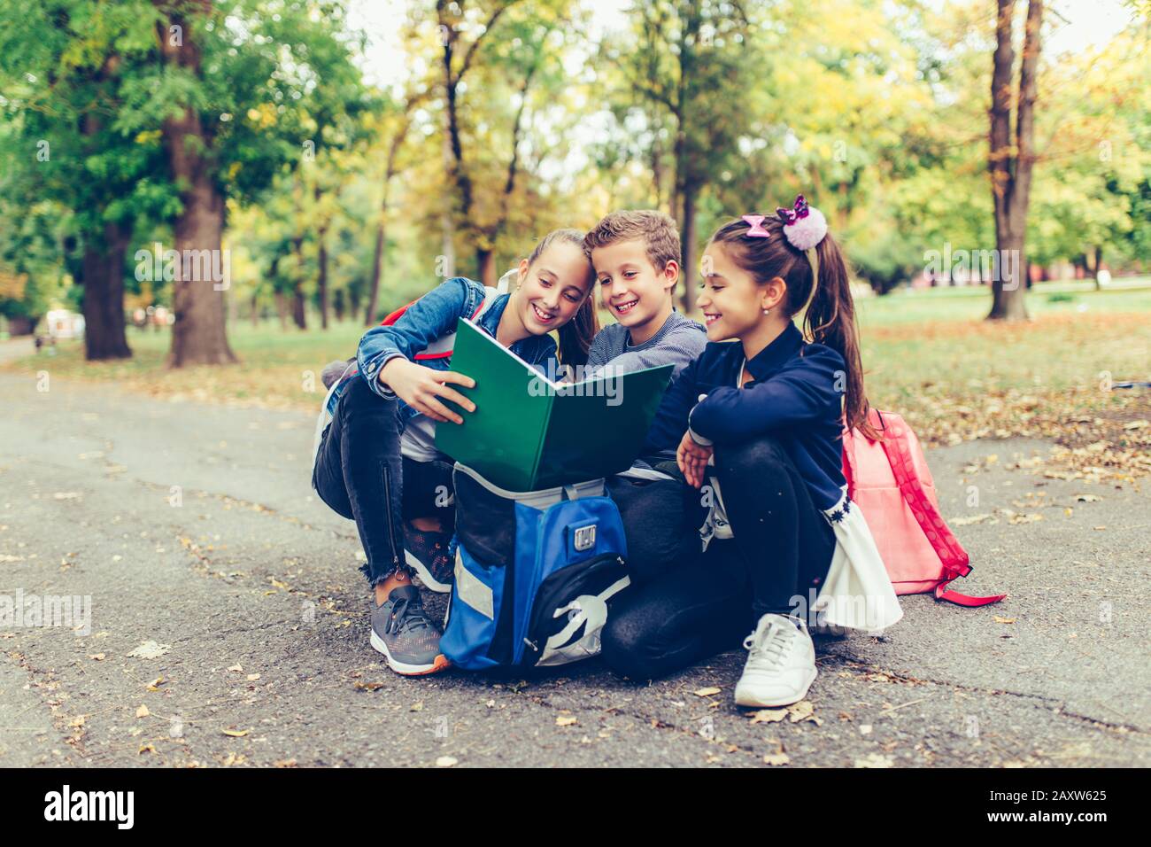 Back to school. Children with backpacks are having fun, talking ...
