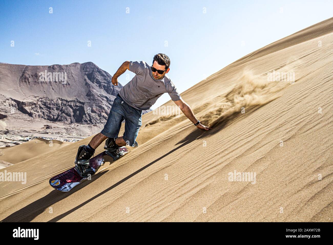 Sandboarding in Cerro Dragon, in Atacama Desert. Iquique, Tarapaca ...