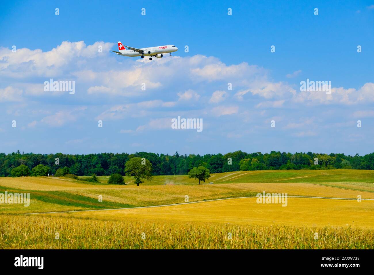 Airplane above beautiful lawns and forest in countryside Stock Photo ...