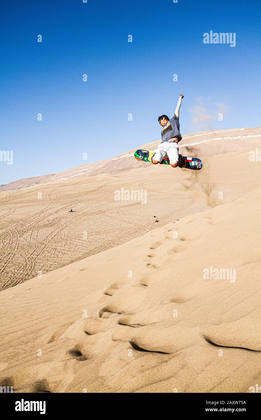 Sandboarding in Cerro Dragon, in Atacama Desert. Iquique, Tarapaca ...