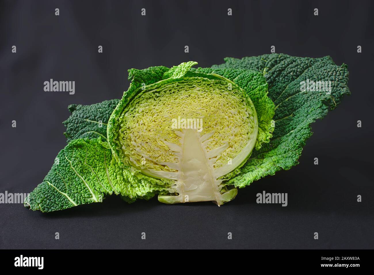 half green cabbage cut on black background Stock Photo - Alamy