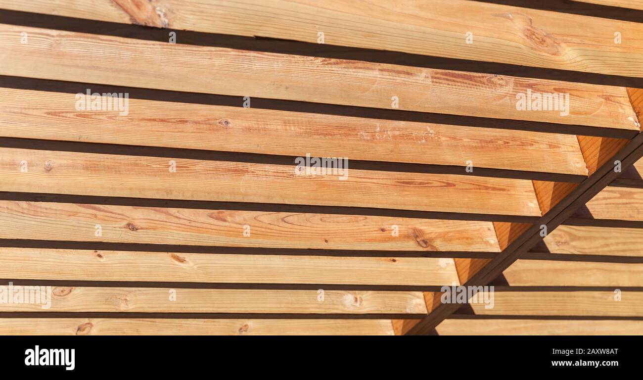 Wooden boards in a row. Sunshade structure fragment. Abstract ...
