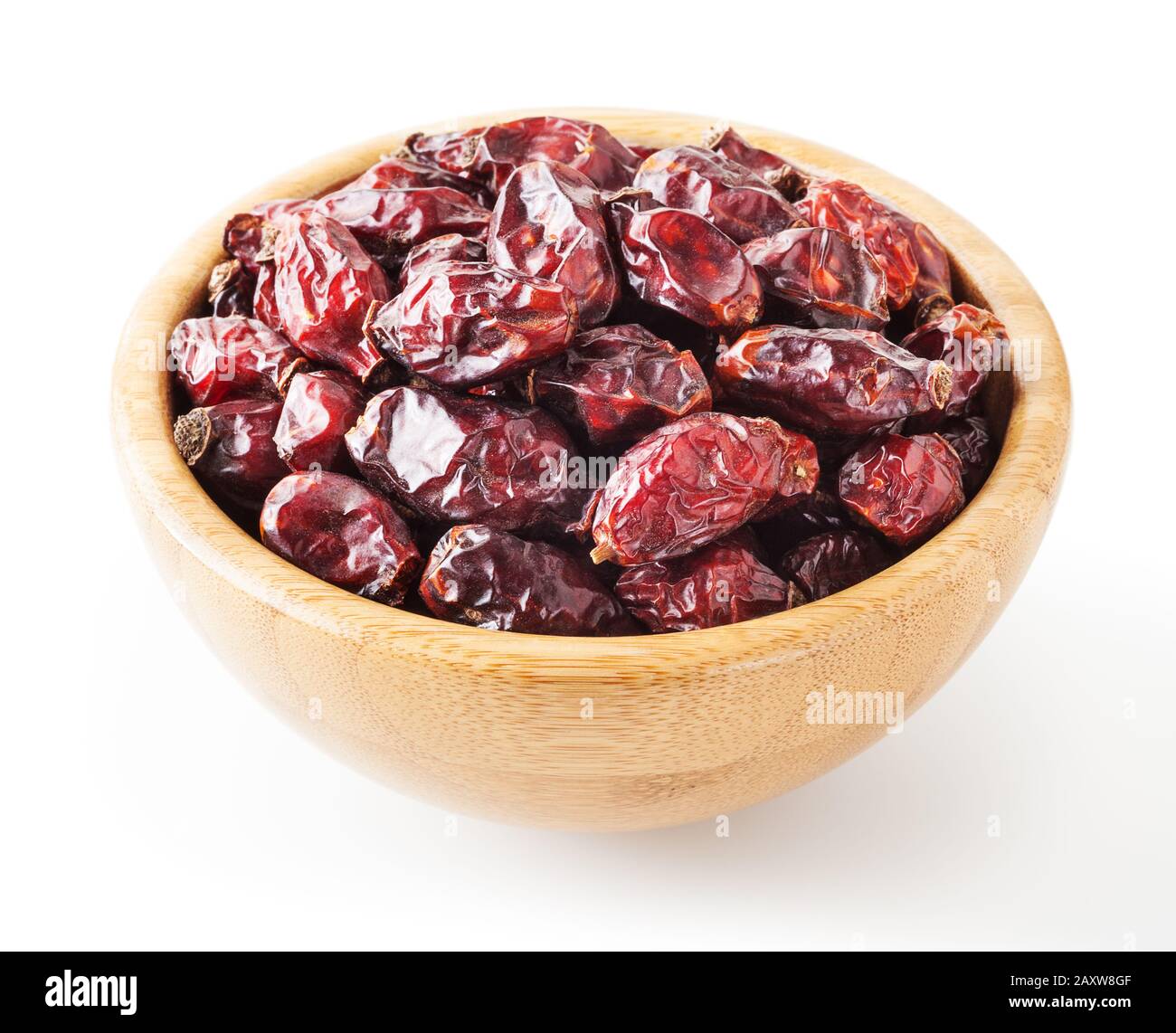 Dried wild rose berries in wooden bowl isolated on white background ...
