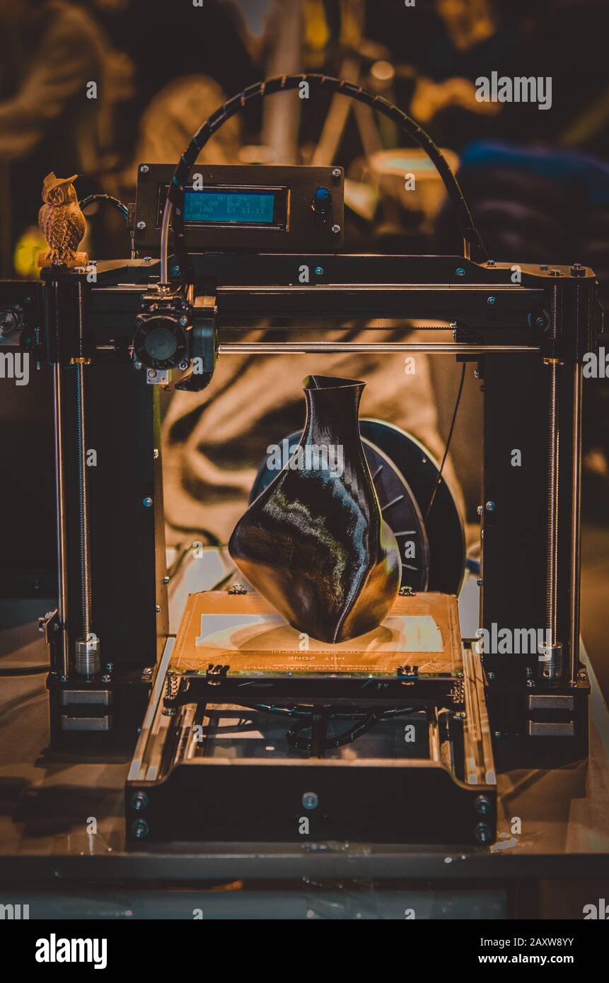 3D printer printing a model in the form of black vase close-up. The ...