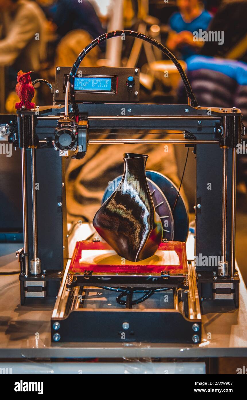 3D printer printing a model in the form of black vase close-up. The ...