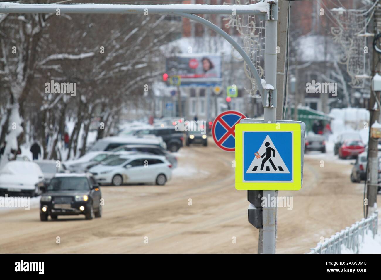 Pedestrian crossing sign on a busy street background. Highway in a ...