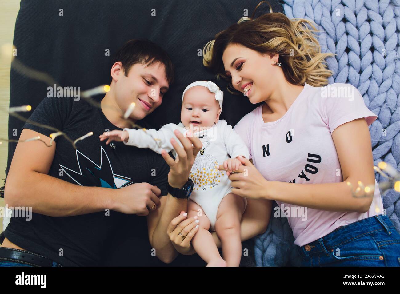 Parents cuddling baby in bed at home. Mom, dad and baby. Happy family ...