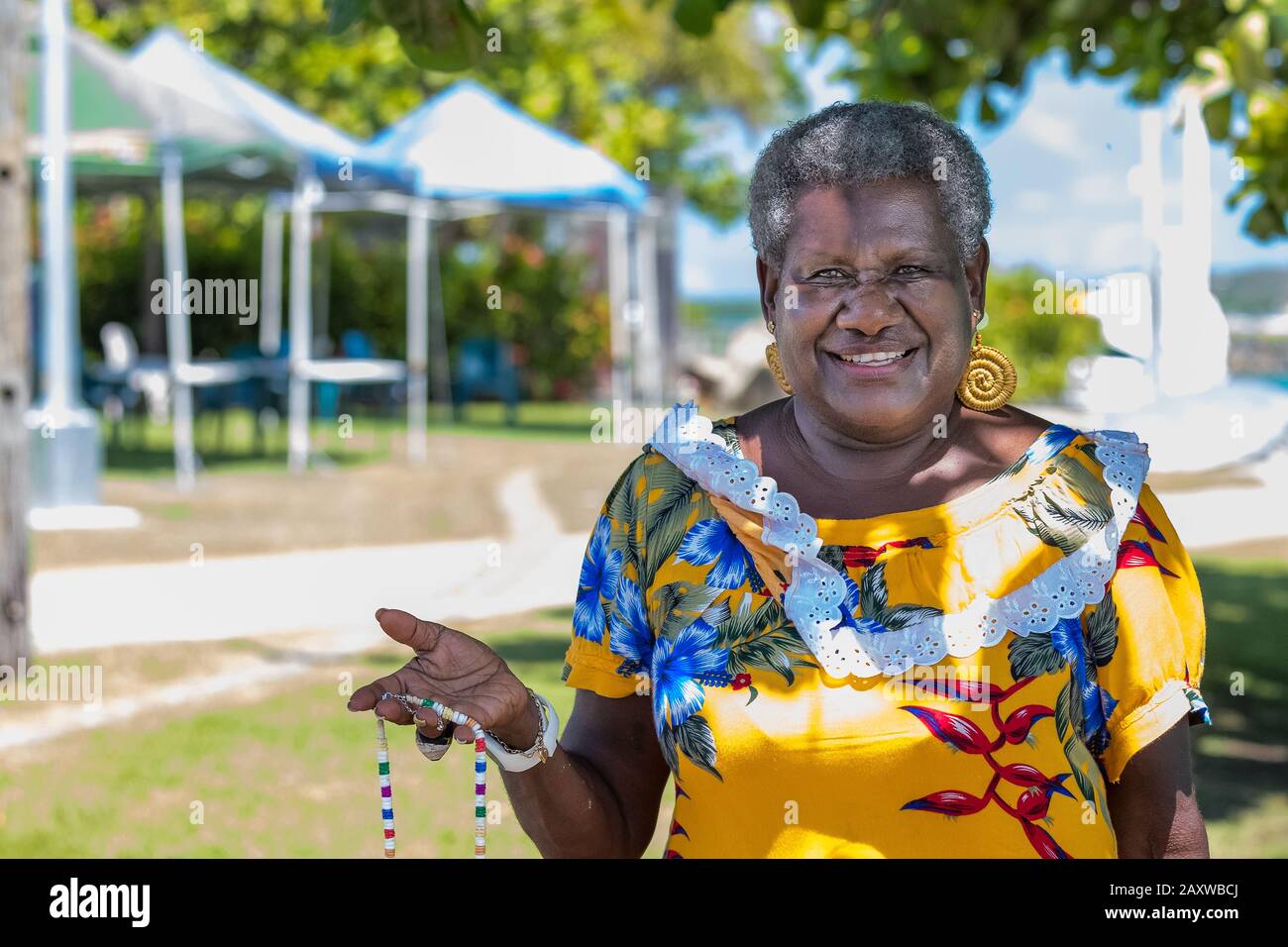 Portrait of a melanesian - australian mature woman smiling, outdoors ...