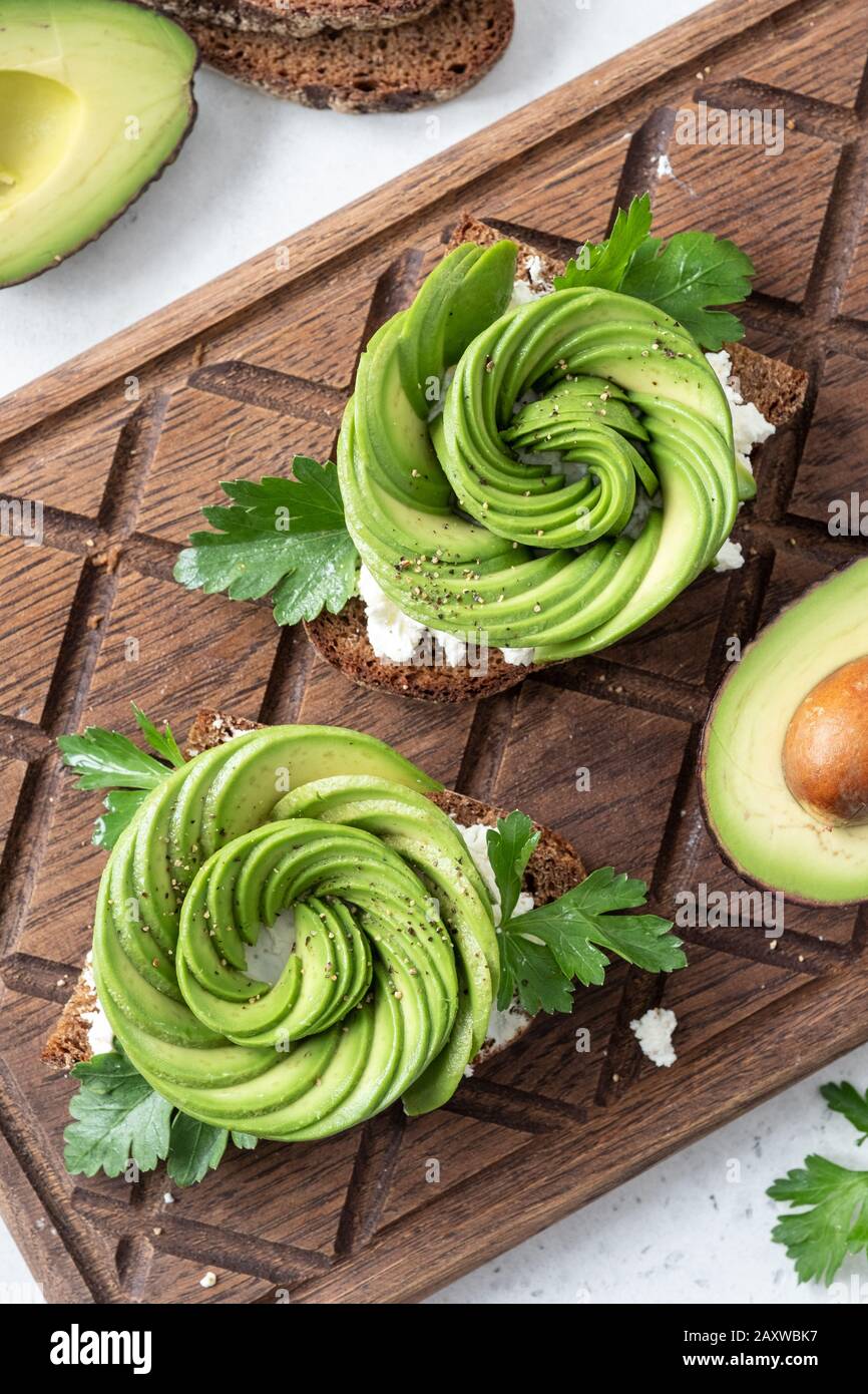 Fresh avocado rose toasts with cream cheese Stock Photo - Alamy