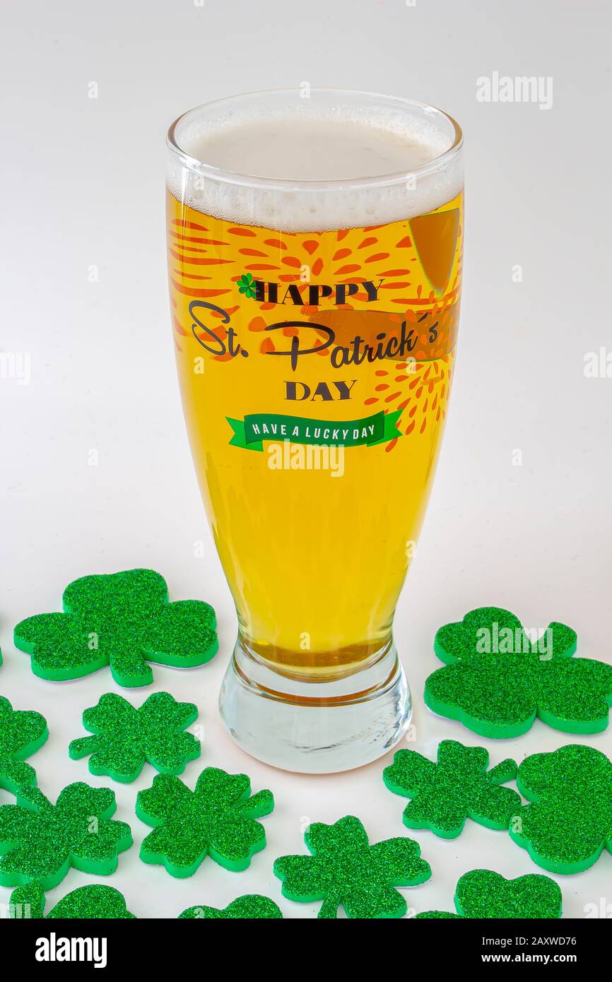 St patrick's days Beer Pint with a green hat and clovers around Stock ...